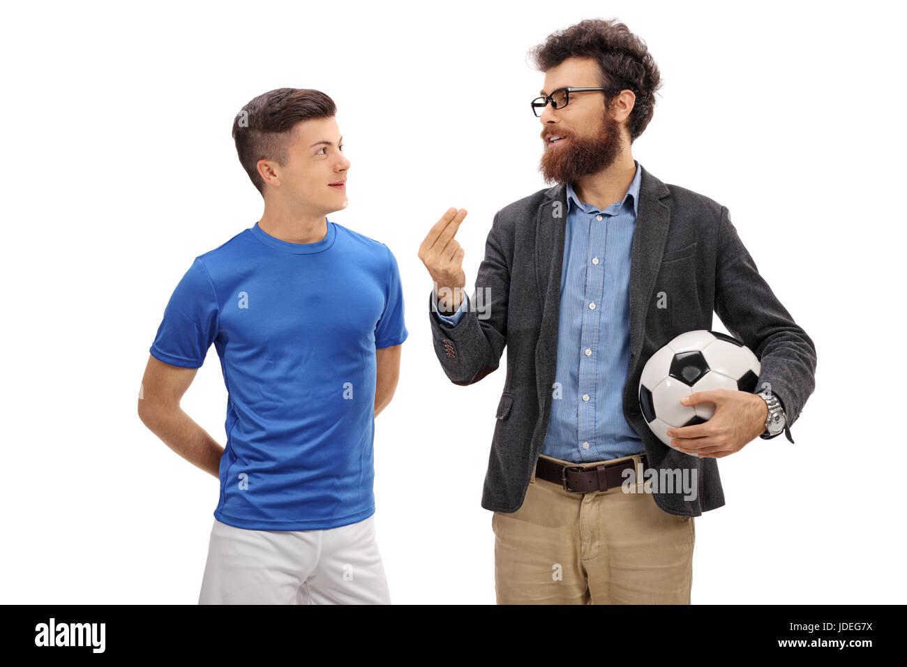 Father with a football explaining something to his teenage son isolated ...
