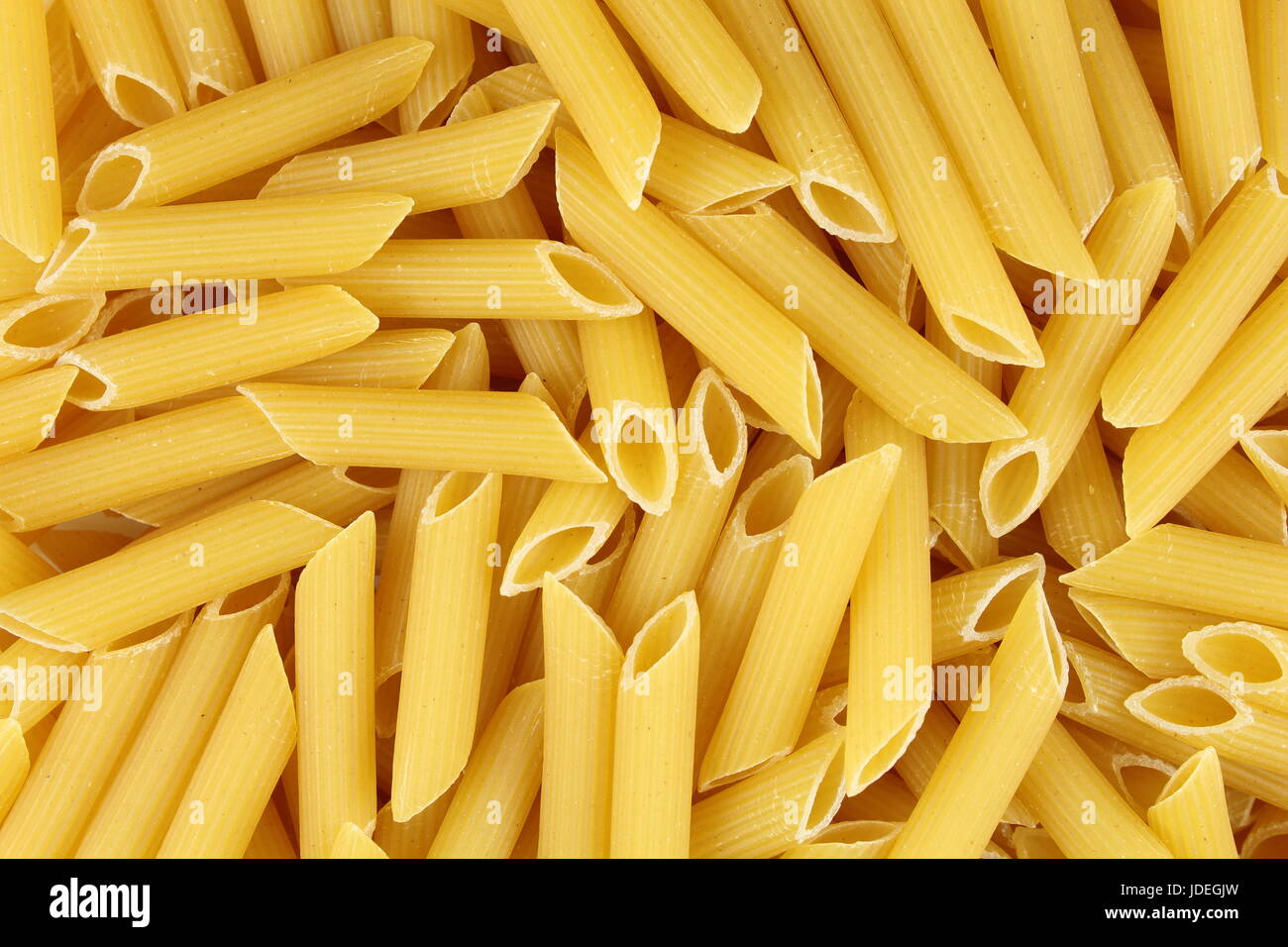 uncooked penne rigate pasta closeup as a food background texture Stock ...
