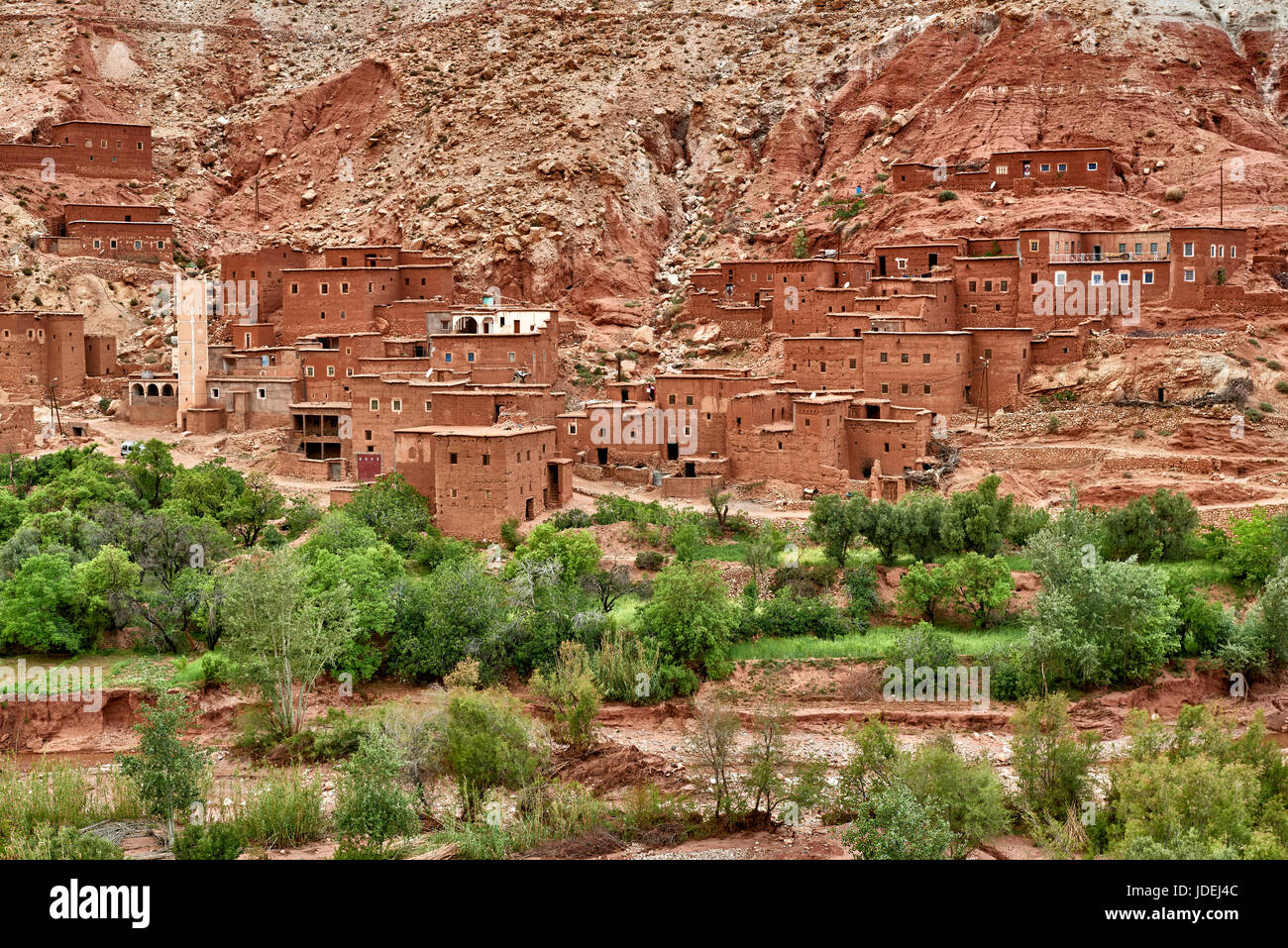typical berber village with clay buildings in a valley near Ait-Ben ...