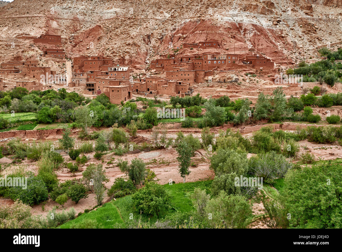 typical berber village with clay buildings in a valley near Ait-Ben ...