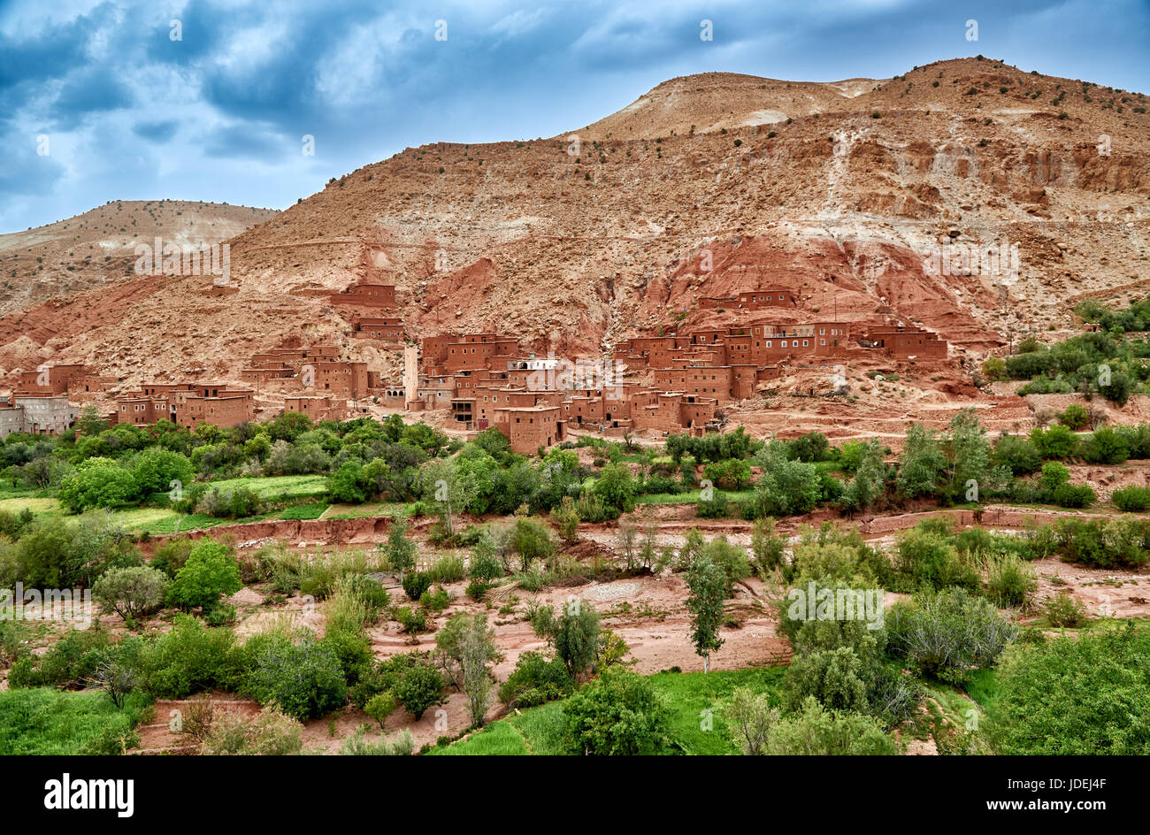 typical berber village with clay buildings in a valley near Ait-Ben ...