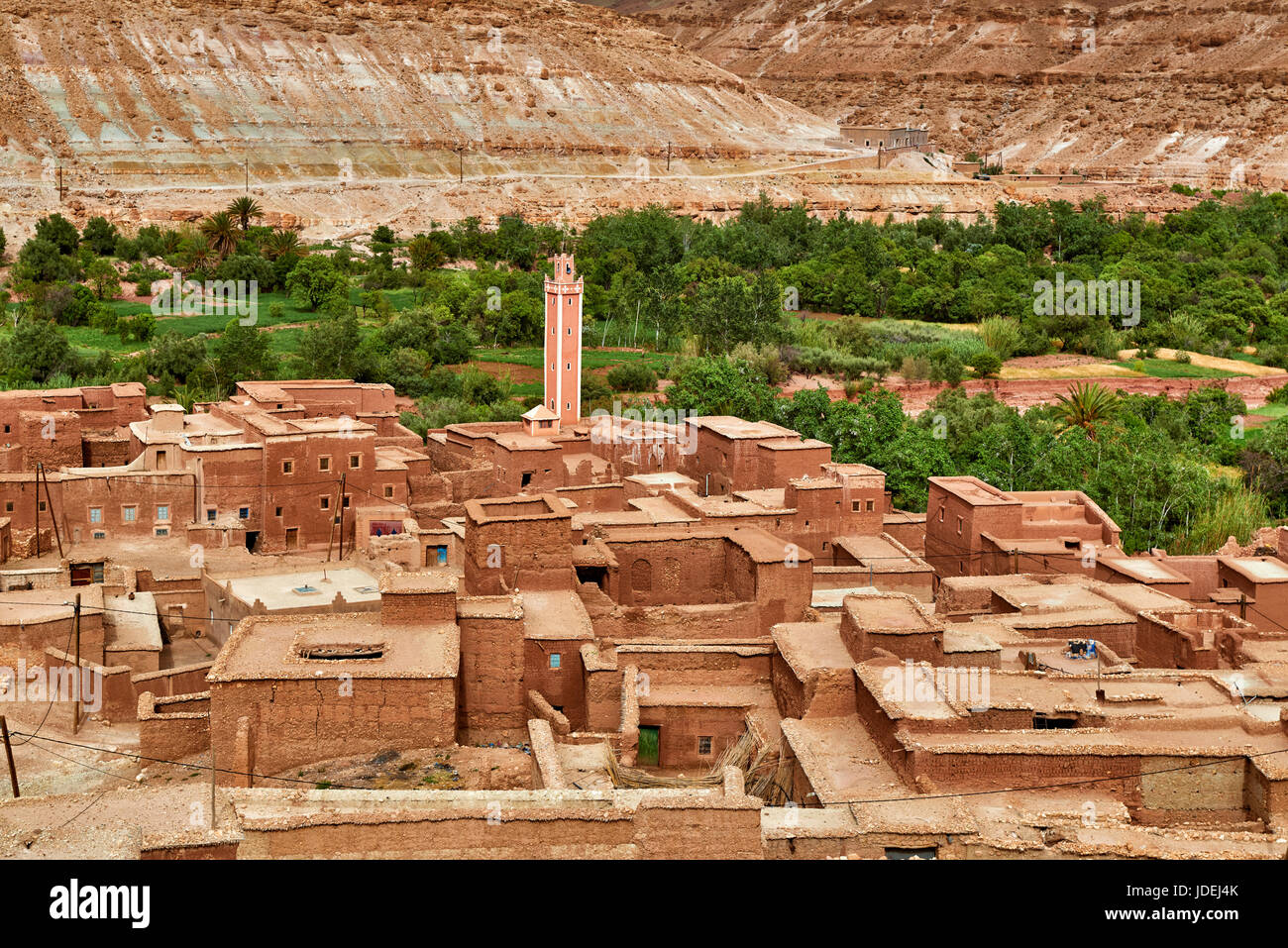 typical berber village with clay buildings in a valley near Ait-Ben ...