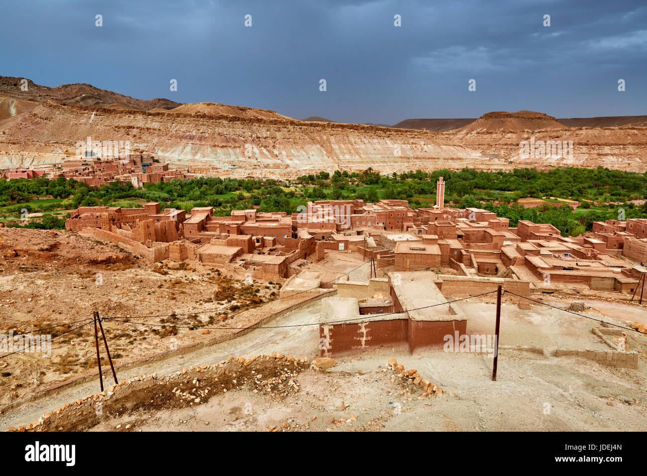 typical berber village with clay buildings in a valley near Ait-Ben ...