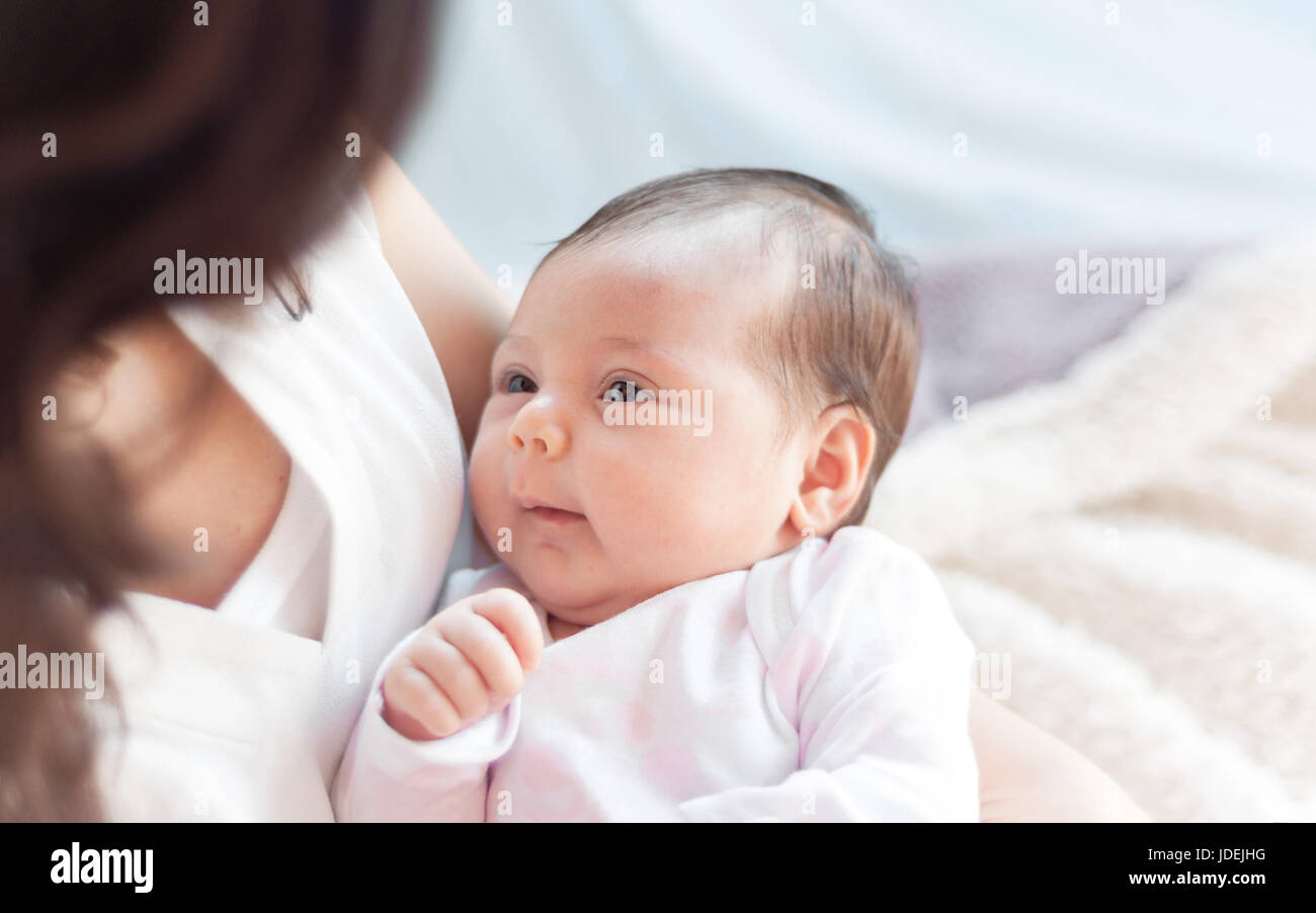 Mother with her newborn baby. Mother is holding her little baby girl ...