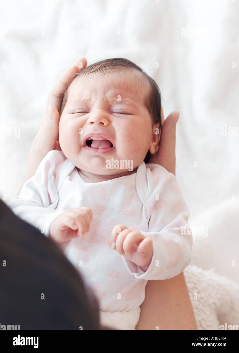 Newborn baby crying in the arms of her mother Stock Photo - Alamy