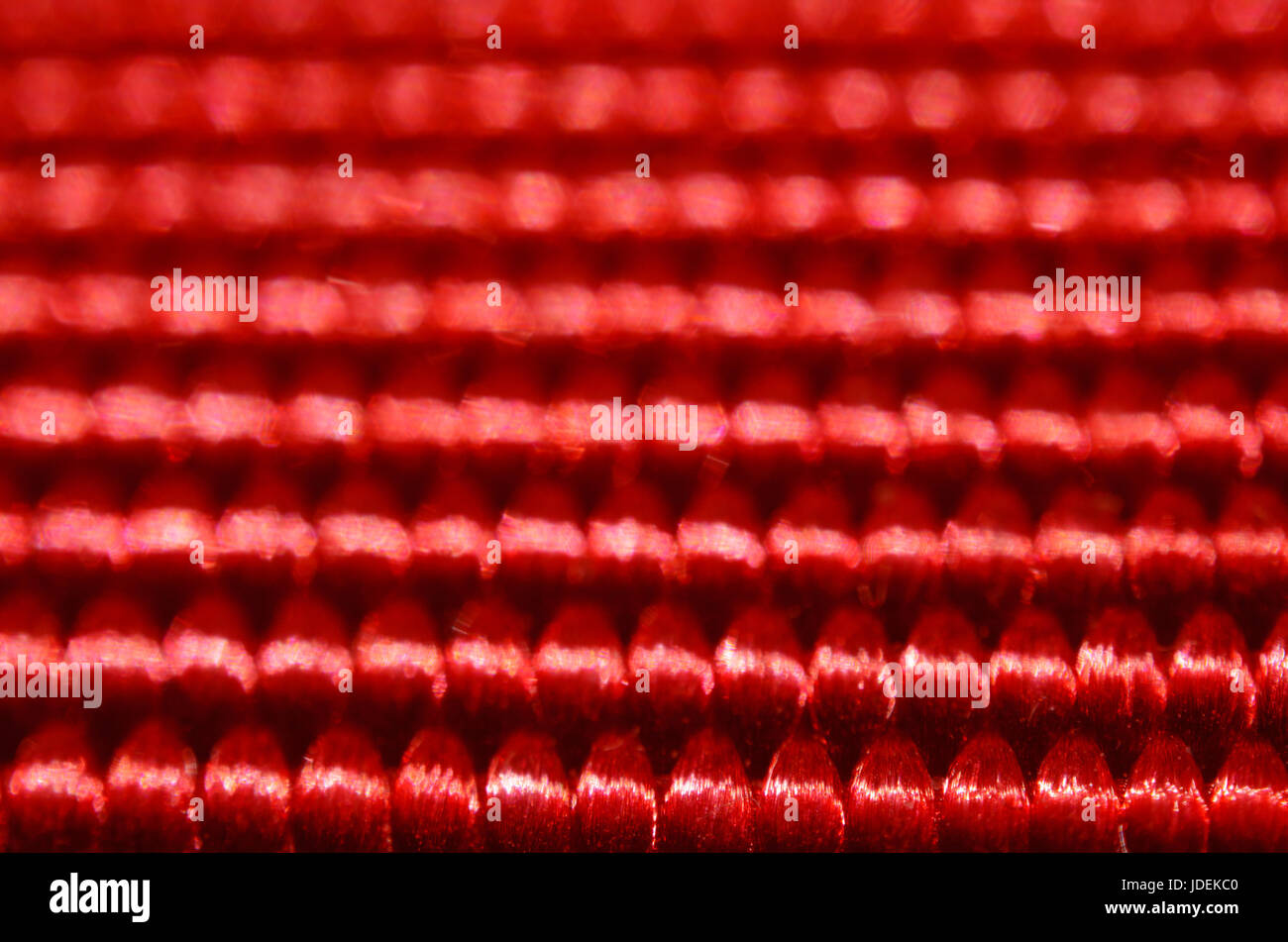Red nylon belt close-up. Shallow depth of field. The interweaving of ...