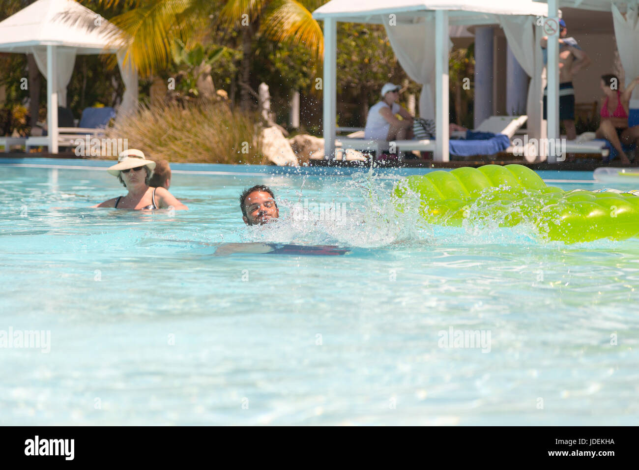 Young man falling from lilo in the pool of Hotel Melia Cayo Coco, Cayo ...