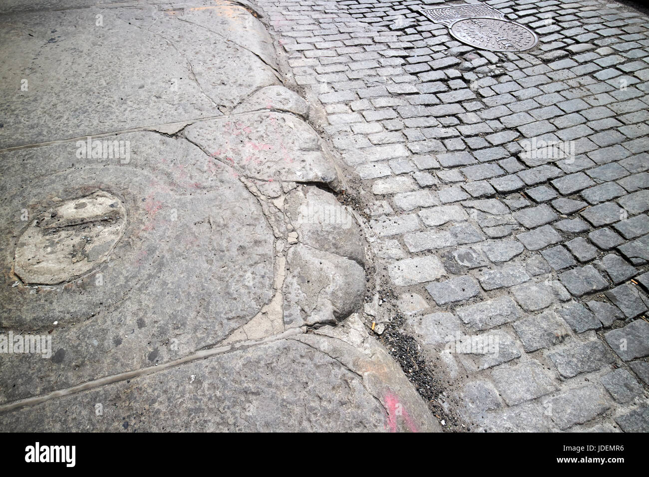 old cracked concrete pavement and worn cobblestoned streets in the ...