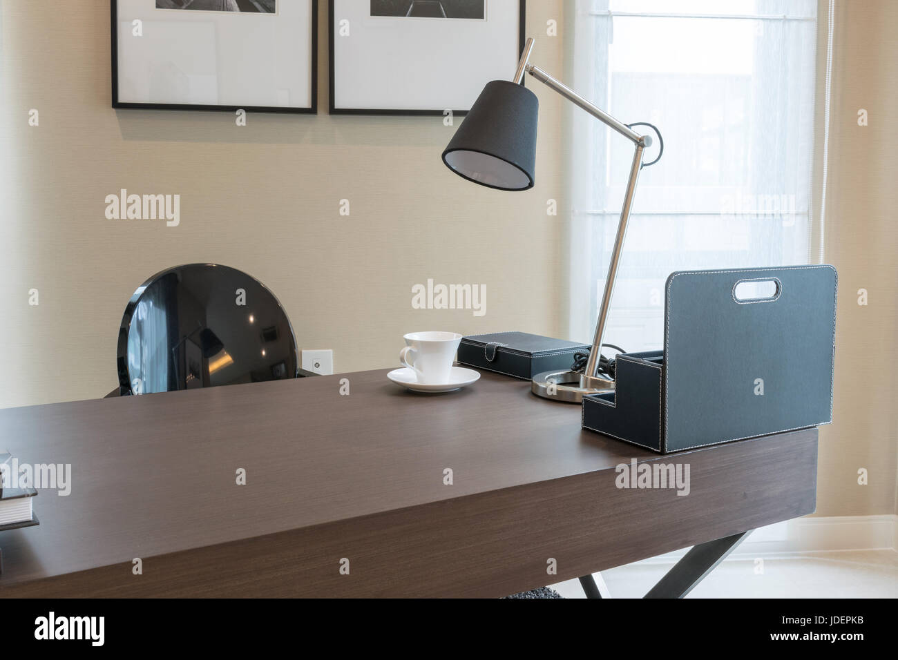 wooden table and books in modern working room interior Stock Photo - Alamy