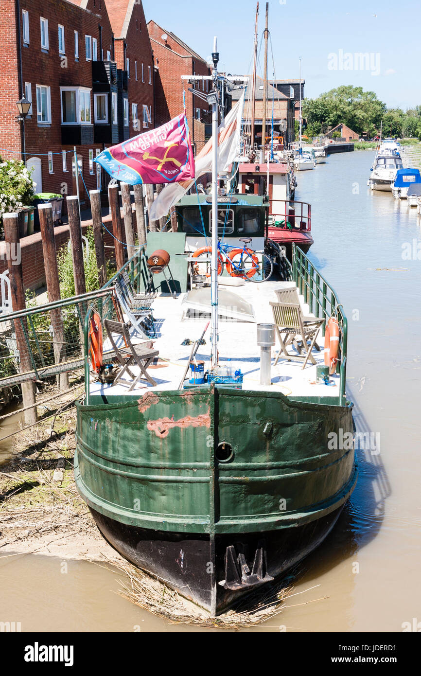 Green river barges used as floating home on renovated quay side at ...