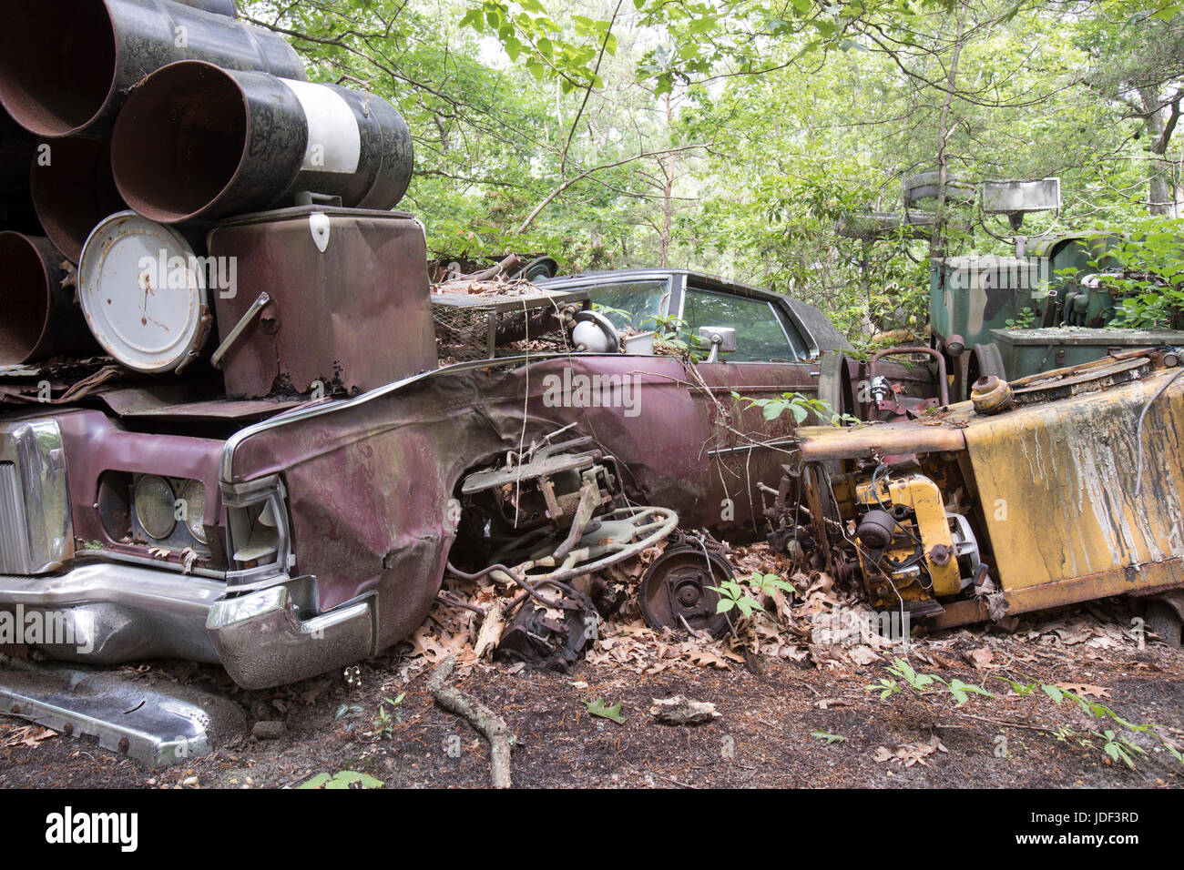 Rusting scrap metal with car and heavy equipment in junkyard Stock ...