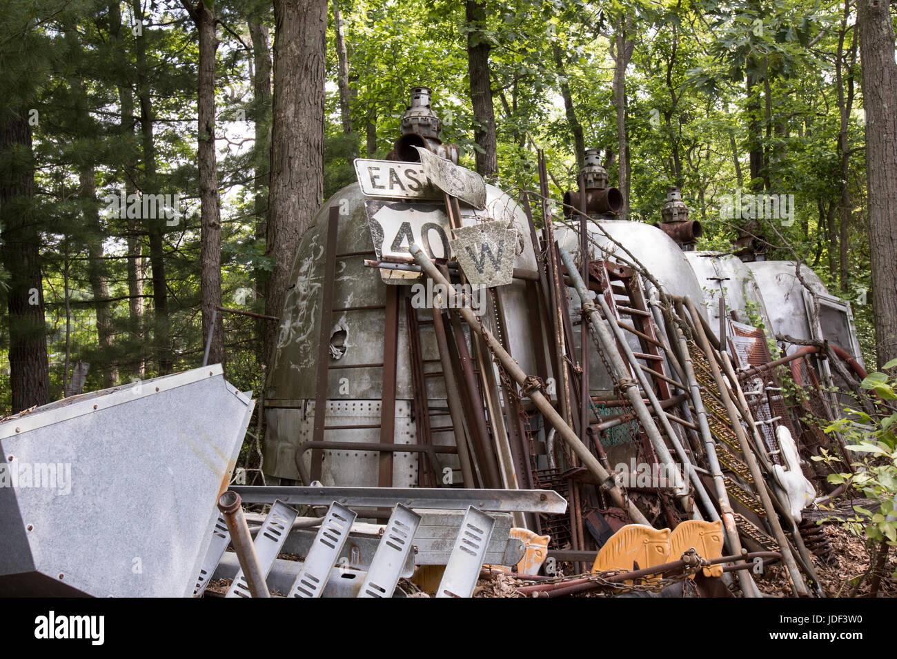 Road signs and airplane parts in woods of junkyard Stock Photo - Alamy