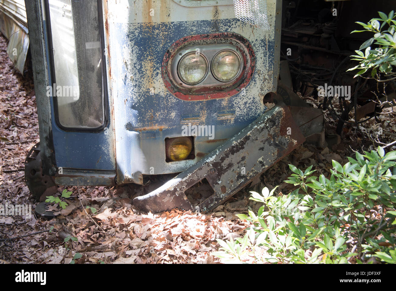 Front of rush old bus in wooded junkyard Stock Photo - Alamy
