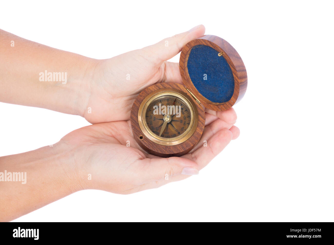 Someones hand holding old vintage compass isolated on white background ...