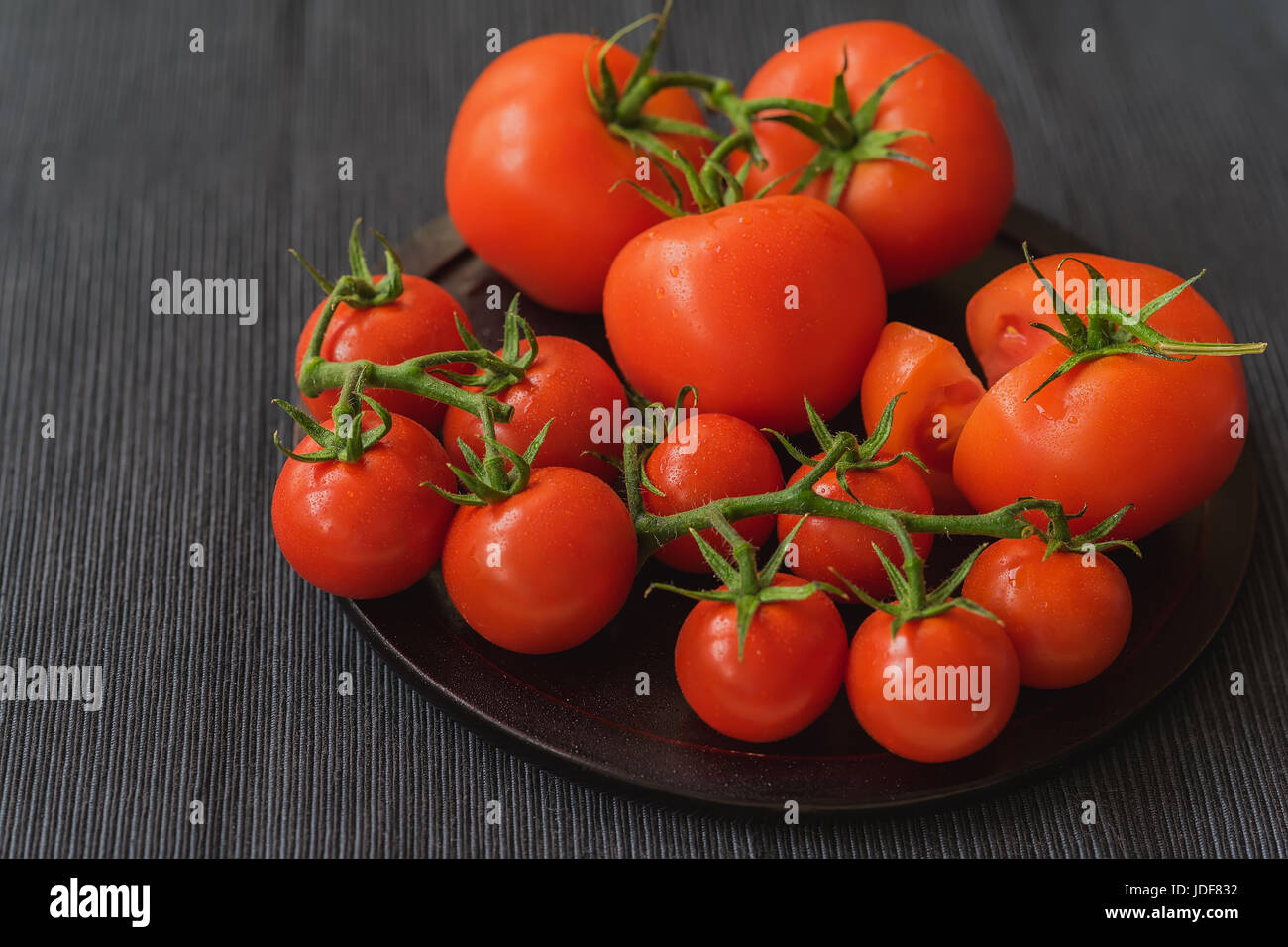 Close-up of fresh red ripe organik tomatoes with water drops on ...