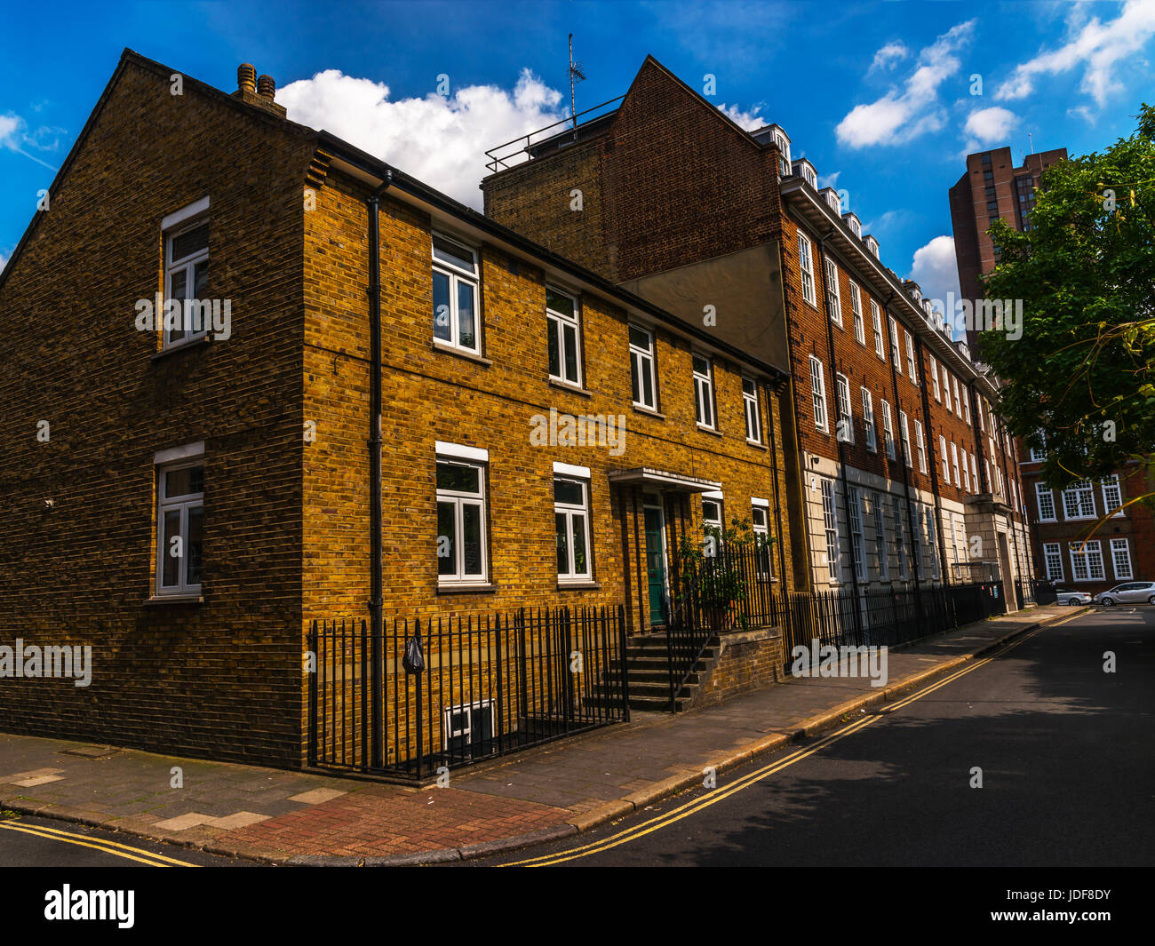 Typical old English buildings, low brick buildings across a narrow ...