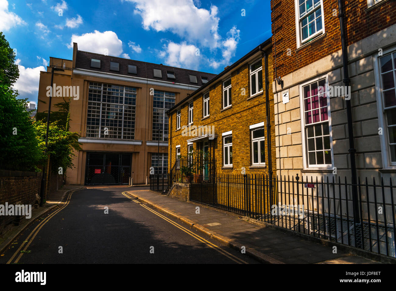 Typical old English buildings, low brick buildings across a narrow ...