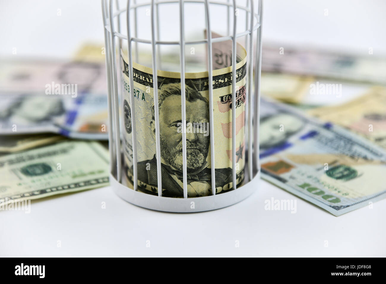 Banknotes trapped inside the cage, behind bars Stock Photo - Alamy
