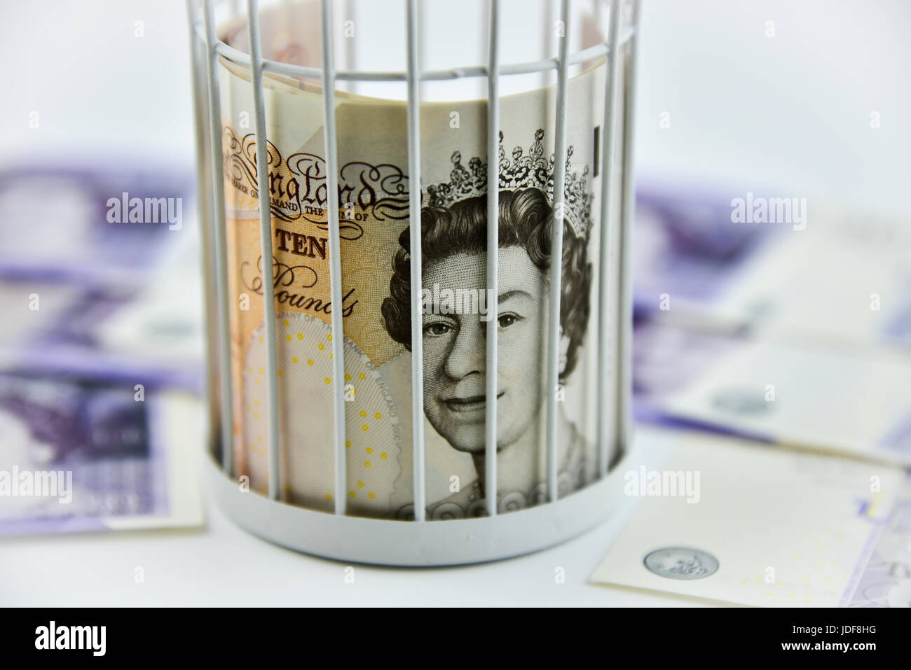 Banknotes trapped inside the cage, behind bars Stock Photo - Alamy