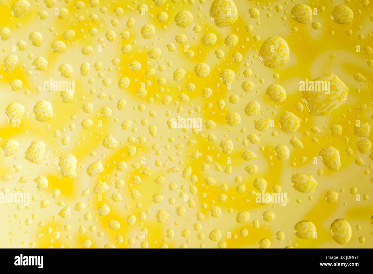 Raindrops on a yellow designed background Stock Photo - Alamy