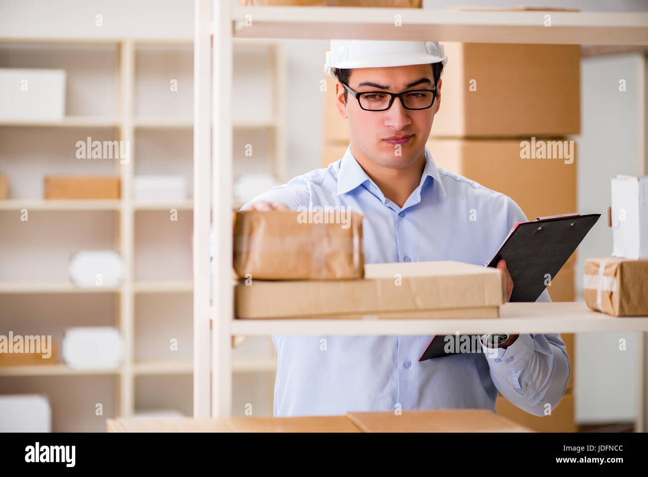 Man working in postal parcel delivery service office Stock Photo - Alamy