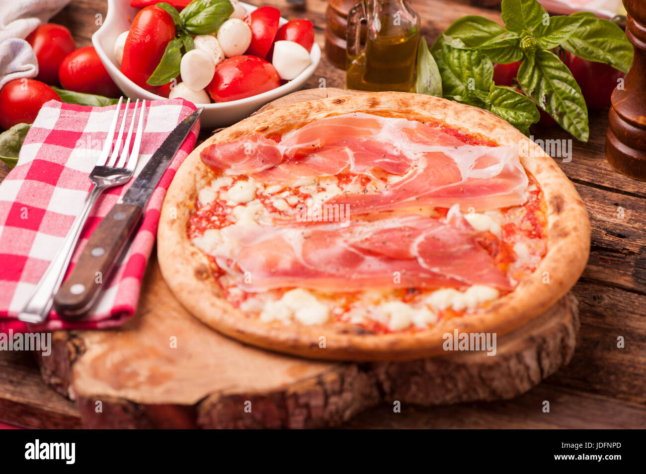 Italian Pizza on rustic wooden table Stock Photo - Alamy