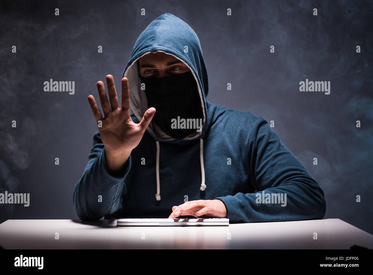 Computer hacker working in dark room Stock Photo - Alamy