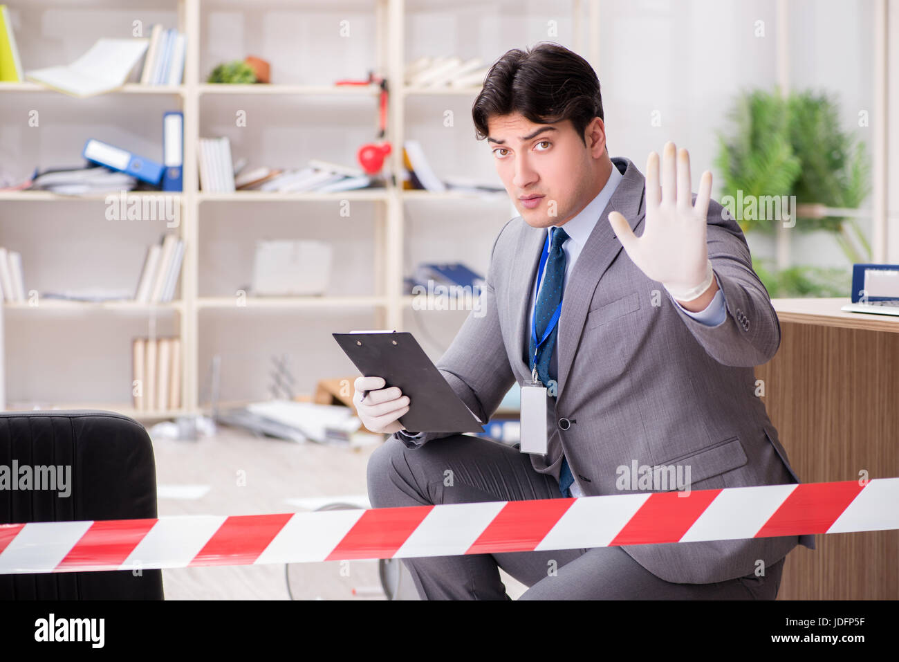 Young man during crime investigation in office Stock Photo - Alamy