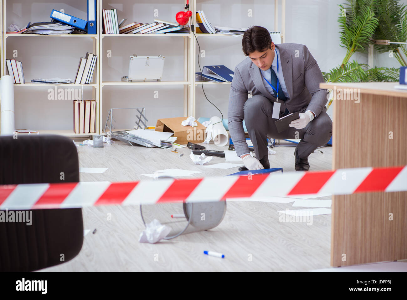 Young man during crime investigation in office Stock Photo - Alamy