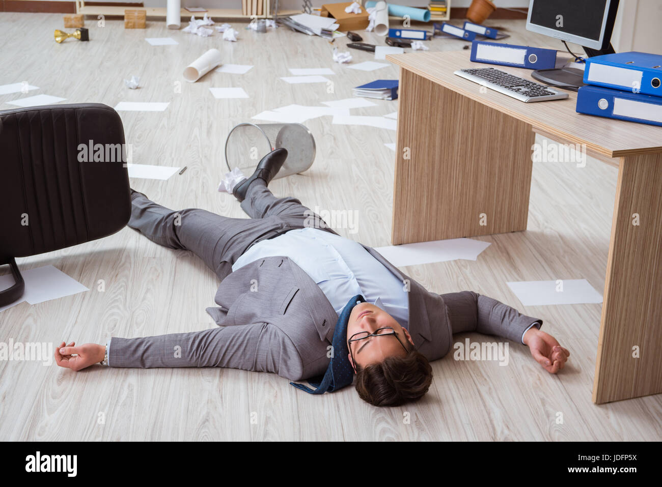 Businessman dead on the office floor Stock Photo - Alamy