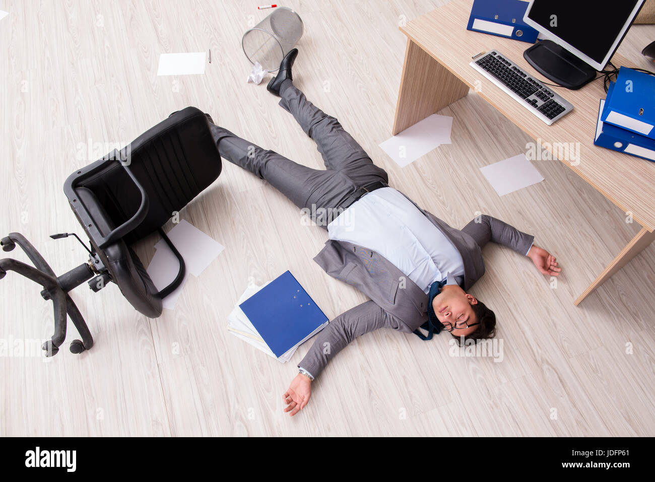 Businessman dead on the office floor Stock Photo - Alamy