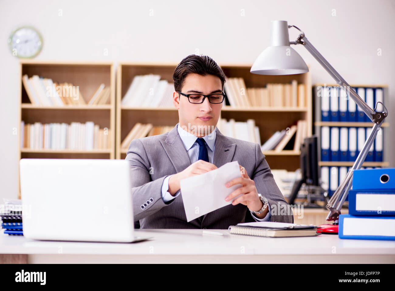 Businessman receiving letter envelope in office Stock Photo - Alamy