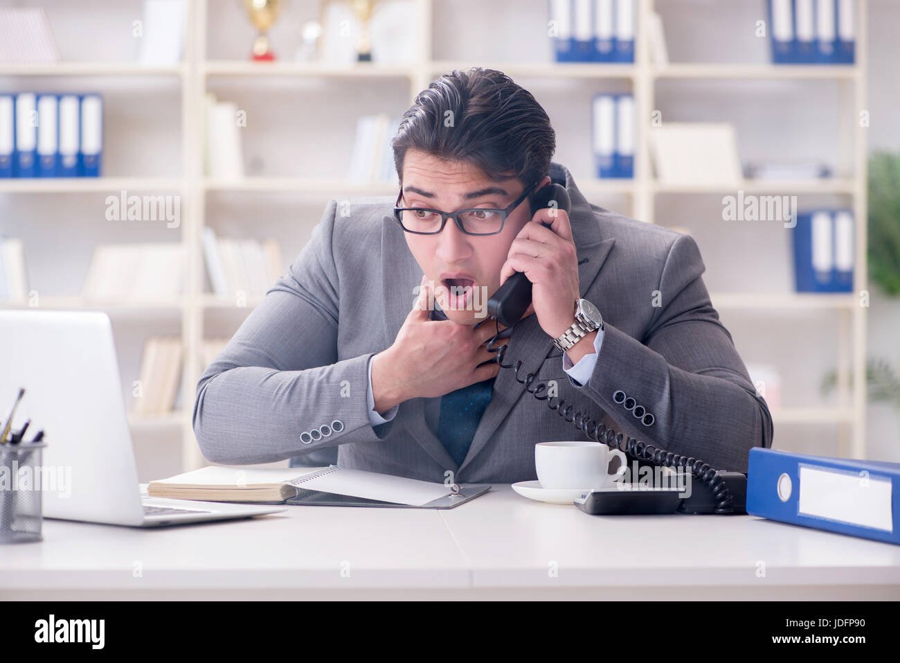 Businessman during fire alarm in office Stock Photo - Alamy