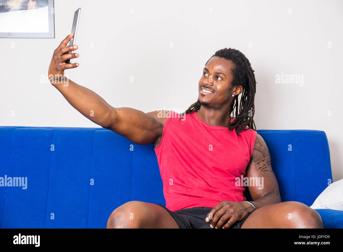 Handsome black muscular bodybuilder man taking selfie with cell phone ...