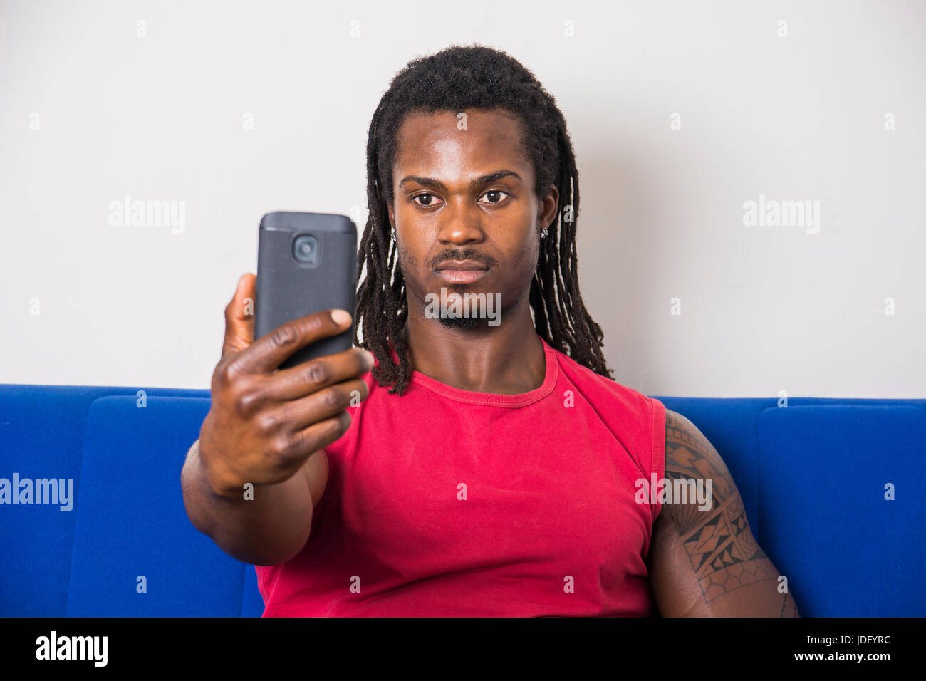 Handsome black muscular bodybuilder man taking selfie with cell phone ...