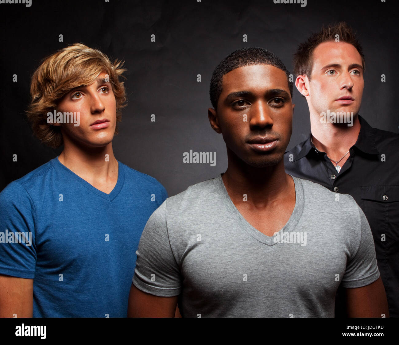 Diverse group of men isolated on grey Stock Photo - Alamy