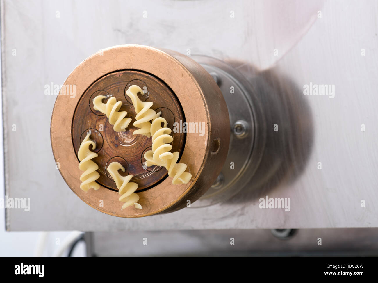 Close up detail of the die plate for making fusilli Italian pasta on an ...