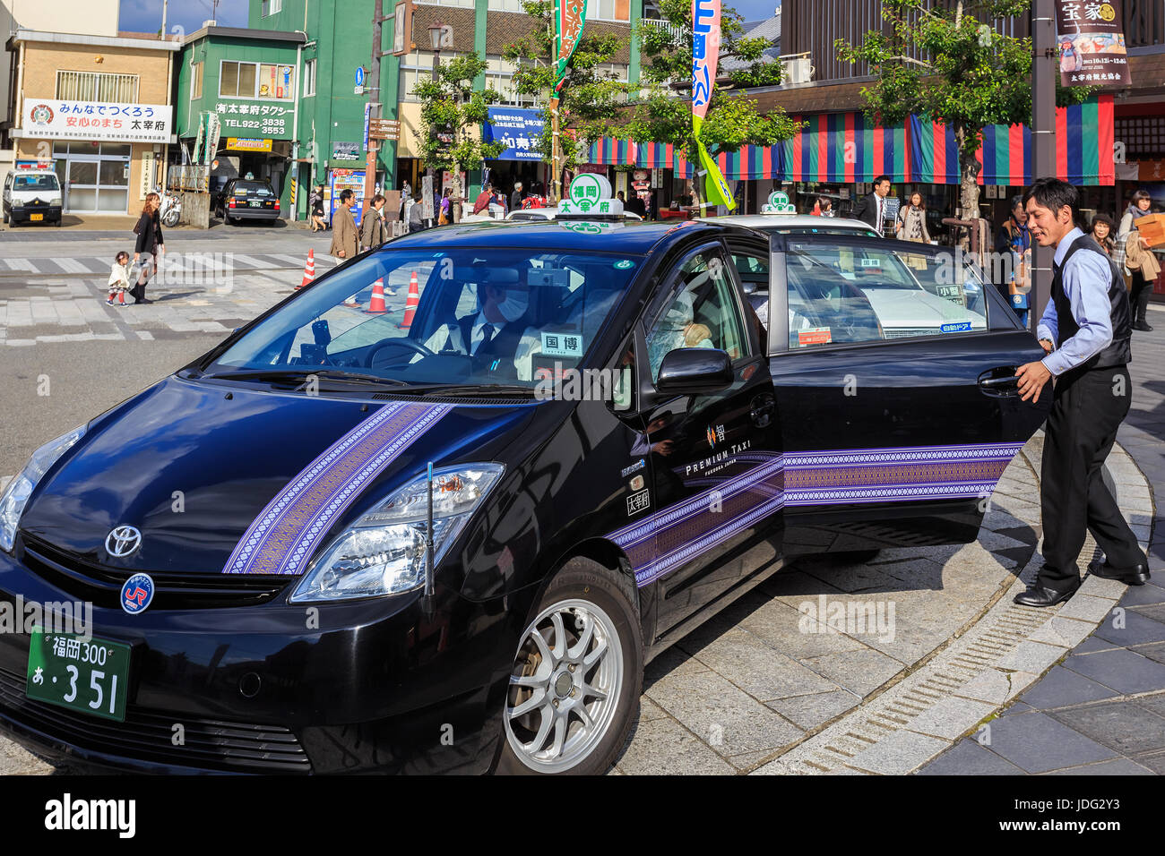 Unidentified Japanese taxi driver with passengers in front of Dazaifu ...
