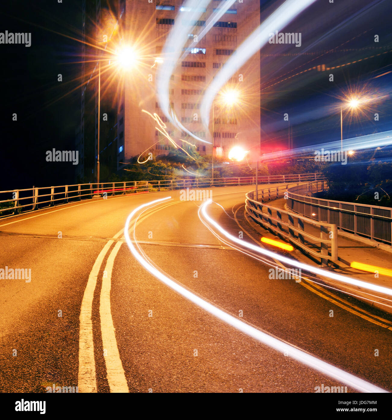 Highway light trails, modern city at night Stock Photo - Alamy