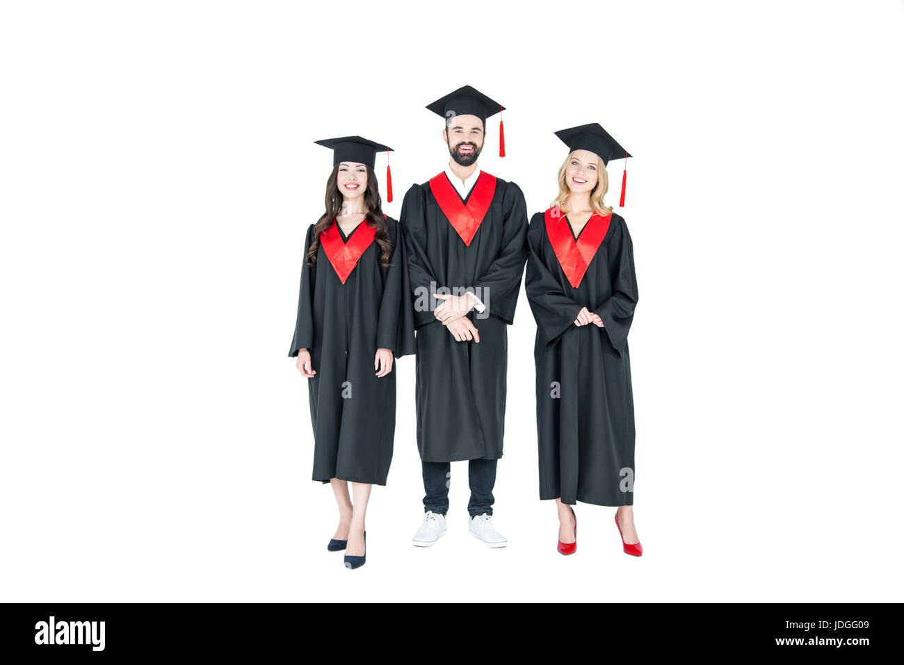 Full length front view of happy students in graduation caps standing ...
