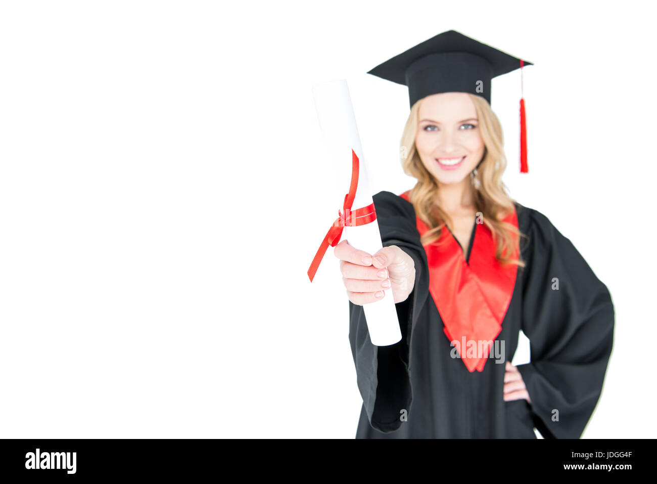 Close-up view of smiling student in graduation gown holding diploma on ...