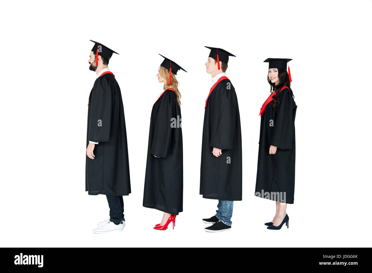 Full length side view of students in academic caps and graduation gowns ...