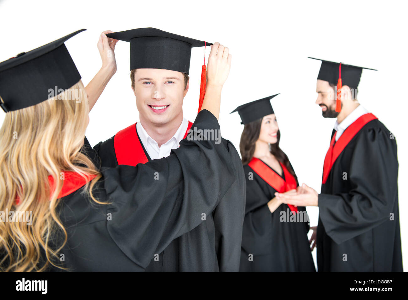 girl fixing student's graduation cap isolated on white Stock Photo - Alamy