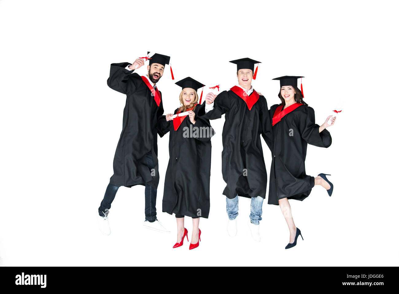 happy young students in graduation caps with diplomas jumping isolated ...