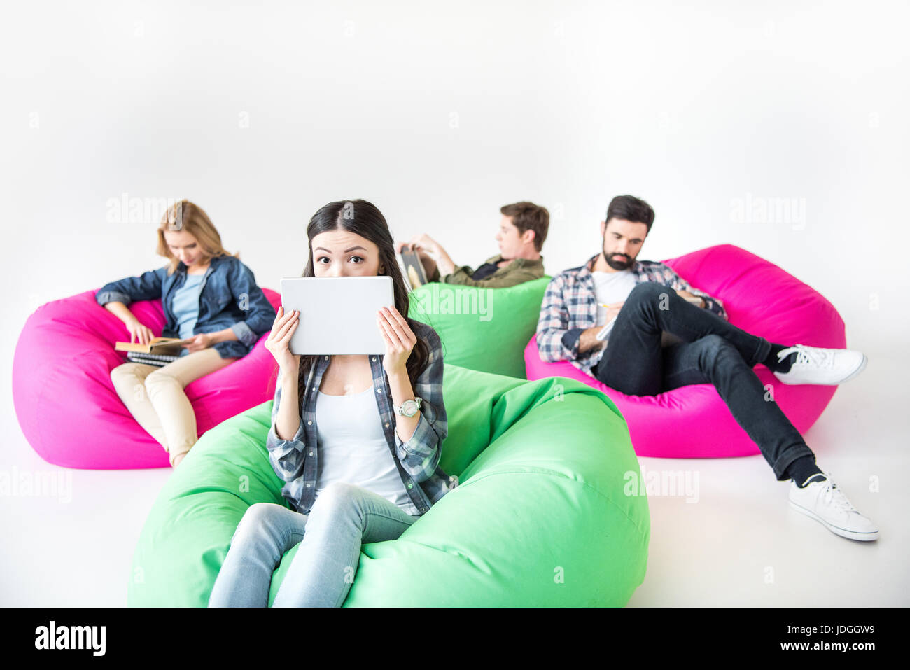 Sitting on bean bags hi-res stock photography and images - Alamy