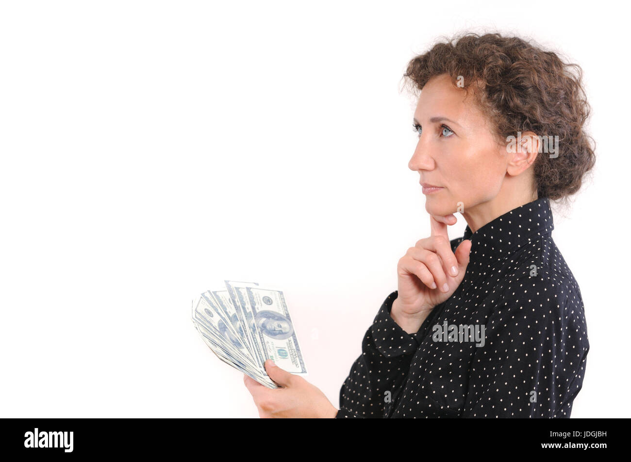 Cheerful attractive lady holding cash and happy smiling over white ...