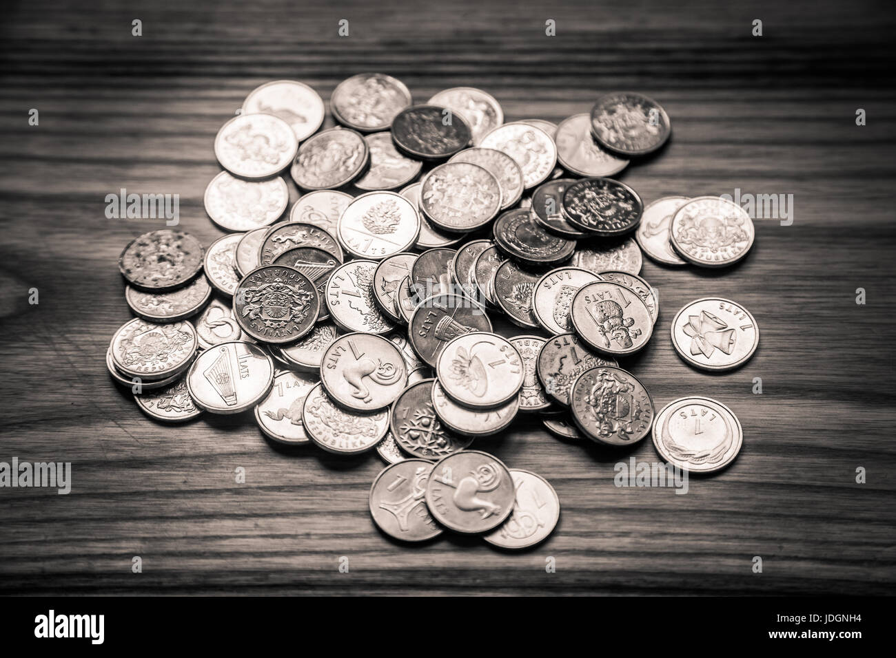 Anniversary lat coins of an old Latvian currency on a wooden background ...