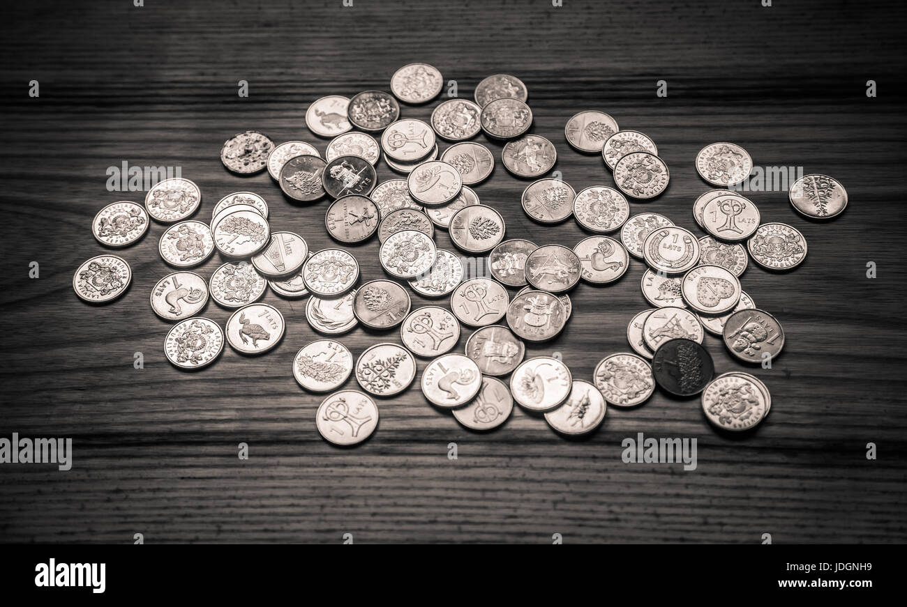 Anniversary lat coins of an old Latvian currency on a wooden background ...