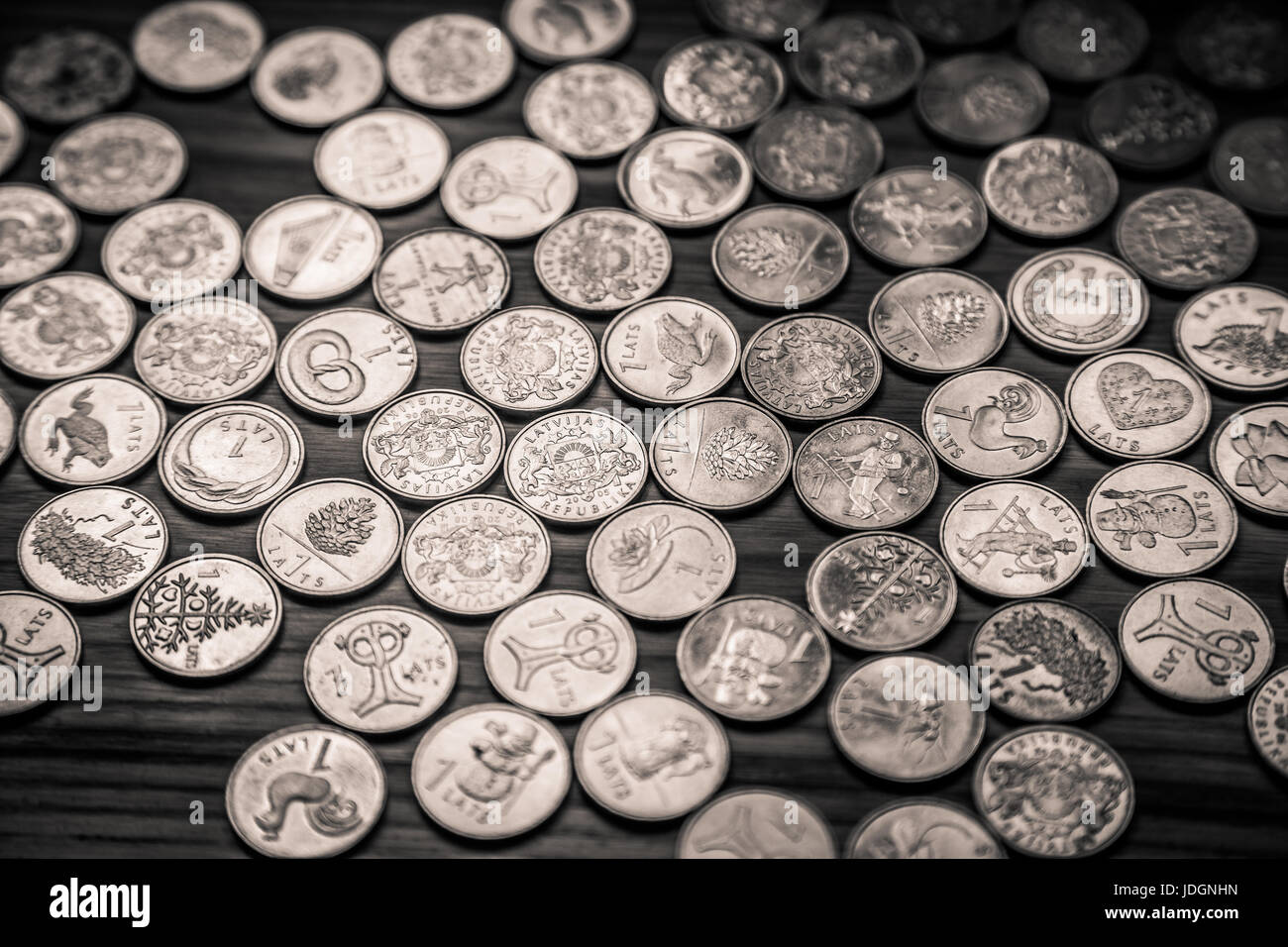 Anniversary lat coins of an old Latvian currency on a wooden background ...