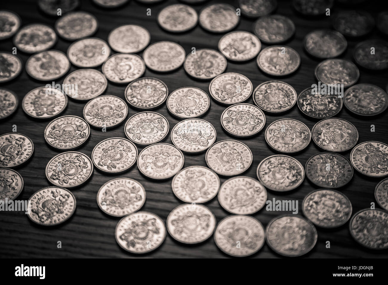 Anniversary lat coins of an old Latvian currency on a wooden background ...